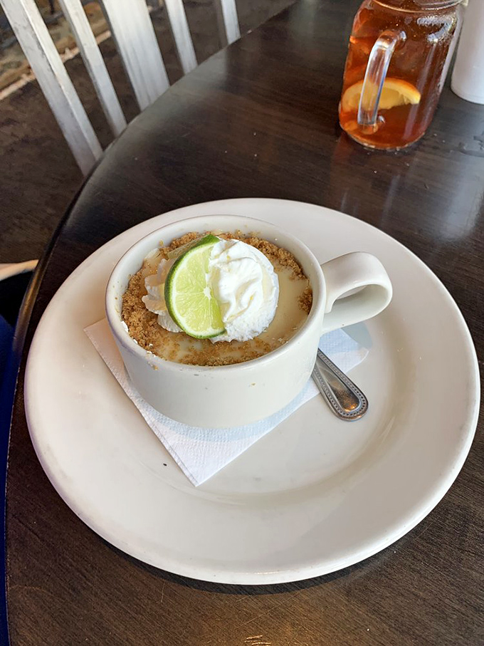 Key lime pie that strikes the perfect balance between sweet and tart, topped with a lime slice that's both garnish and warning label.