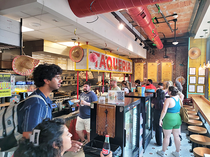 The bustling counter at El Jefe's, where hungry patrons line up for authentic Mexican street food that's worth every minute of the wait.