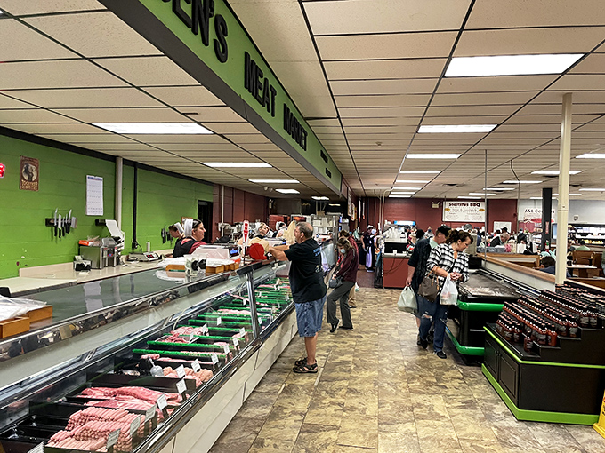 Butchers stand ready behind gleaming cases of fresh cuts. The green walls aren't just decorative&mdash;they're the perfect backdrop for meat that's ready for its close-up.