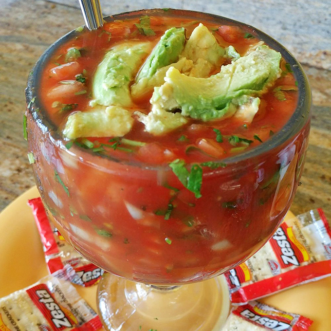 This isn't just cocktail sauce—it's a vibrant sea of tomato, cilantro, and lime embracing chunks of tender shrimp and avocado. Summer in a glass!