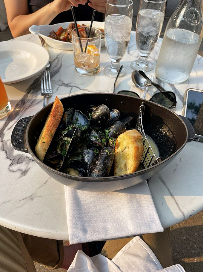 Mussels that clearly took a first-class trip from the ocean to your table, arriving with crusty bread perfect for capturing every drop of broth.
