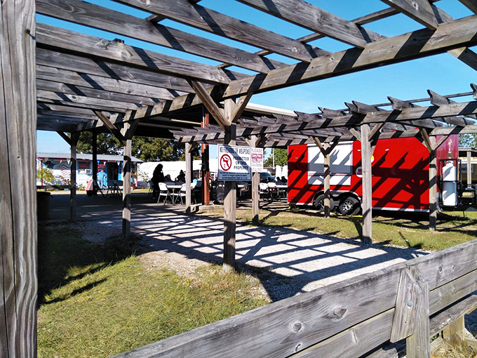 Wooden beams frame the market like a rustic art gallery. The architecture of anticipation for what you'll discover inside.