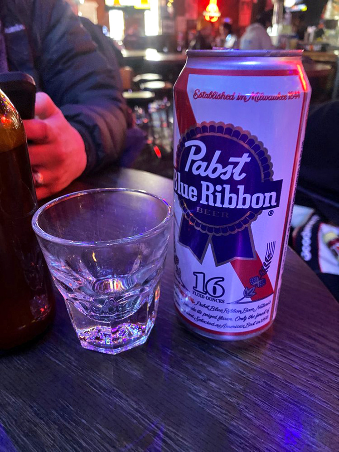 A PBR tallboy: the quintessential dive bar communion. This isn't just beer&mdash;it's liquid tradition in the temple of fried chicken.