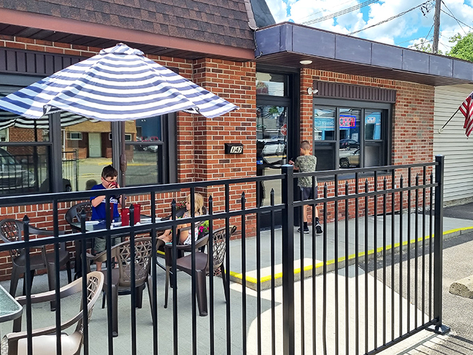 Outdoor dining under striped umbrellas &ndash; where conversations flow as freely as the beverages and nobody's checking their watch.