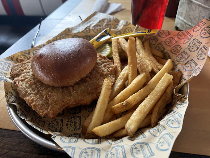 Indiana's unofficial state sandwich&mdash;the breaded pork tenderloin&mdash;served properly: comically oversized, golden-crisp, and requiring strategic first-bite planning.