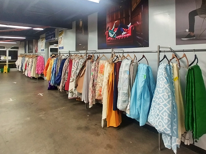 A rainbow of fabrics tells stories of homes past, each dress and shirt holding memories while waiting for new adventures.