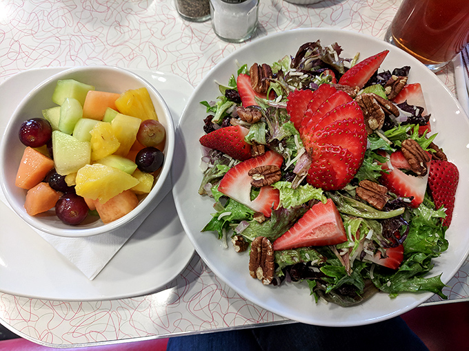 A salad that makes eating greens feel like a reward rather than a punishment, with strawberries playing the role of nature's candy.