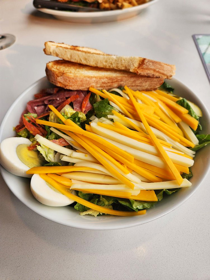 A salad that actually excites: vibrant cheese, perfectly halved eggs, and enough color to make your usual desk lunch weep with inadequacy.