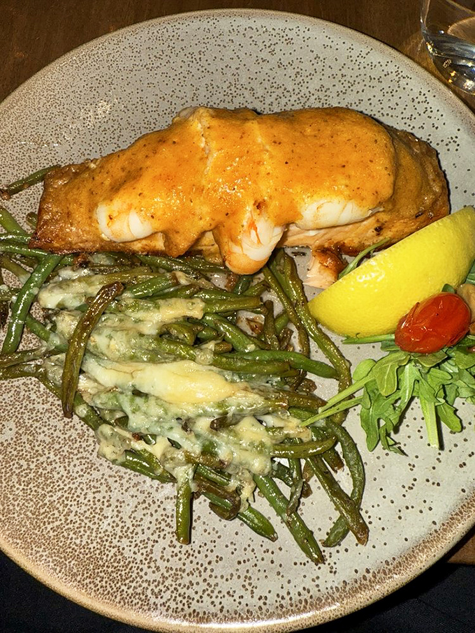 Salmon wearing a sunset-colored sauce lounges atop green beans that clearly went to finishing school. Seaside luxury, mountain-view included.