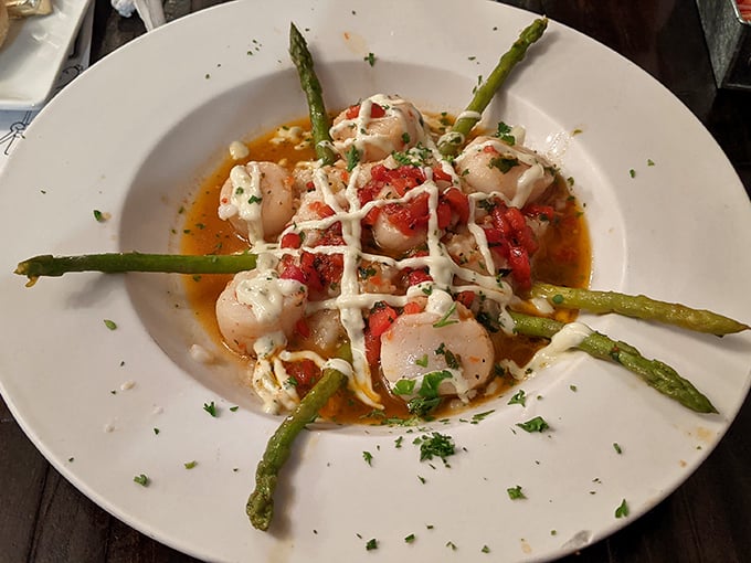 Scallops arranged like the points of a compass, guiding you through a sea of delicious sauce.