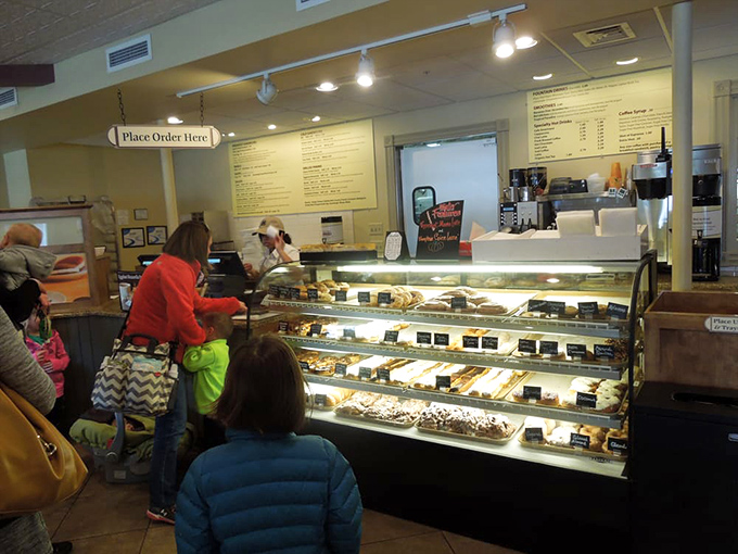 The universal language of anticipation. Customers line up at the display case, united in the timeless human tradition of pointing at delicious things and saying "that one."