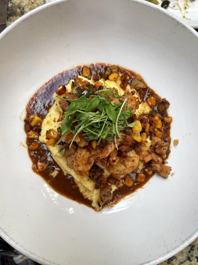 Shrimp and grits elevated to mountain heights. That sauce is having a moment, and those microgreens aren't just for show.