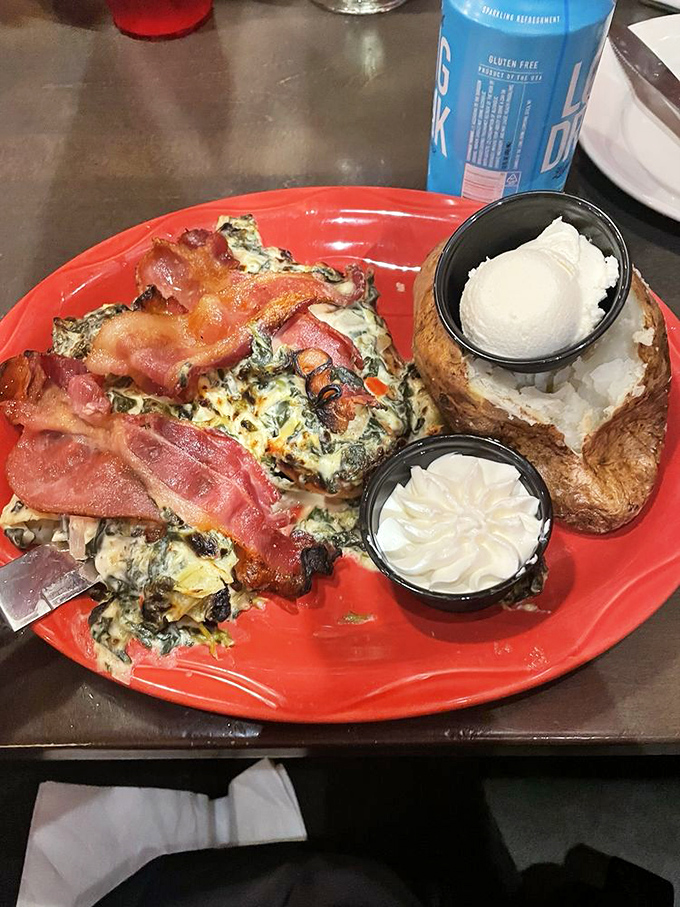 Spinach artichoke chicken with a loaded baked potato&mdash;proof that sometimes the best things in life come on red plates.