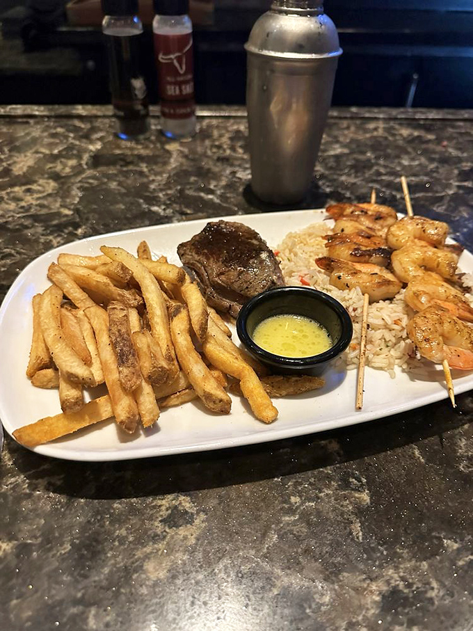 Land meets sea in perfect harmony&mdash;a tender steak alongside skewered shrimp with seasoned fries. It's the surf and turf for those who refuse to choose.