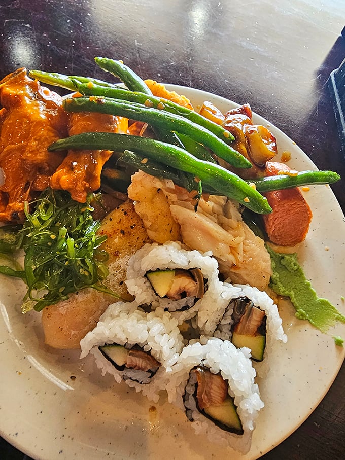 A plate that tells the story of culinary wanderlust &ndash; where sushi, green beans, and various Asian-inspired dishes coexist in delicious harmony.