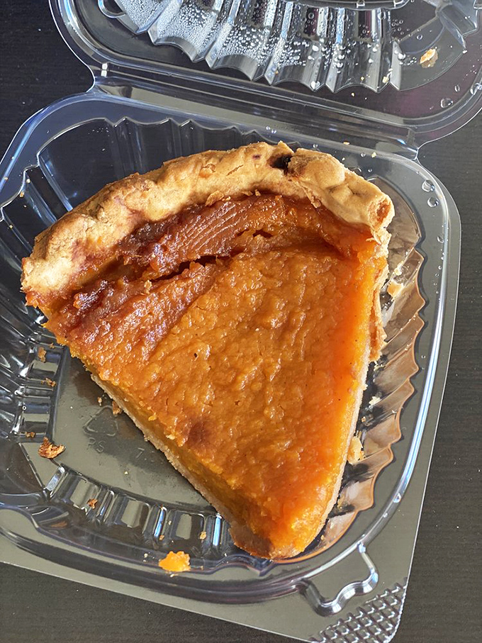 Sweet potato pie that makes you wonder why people bother with other desserts. This slice isn't just food—it's edible nostalgia wrapped in a flaky crust.