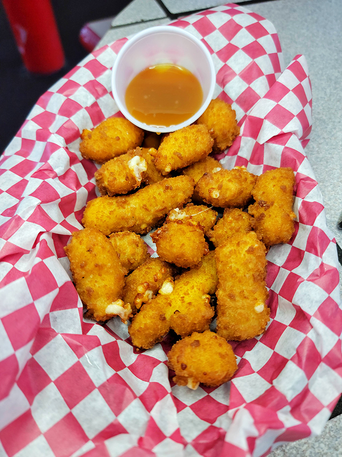 Golden nuggets of potato perfection with dipping sauce standing by. Tater tots: the comfort food that makes adults feel like kids again. 