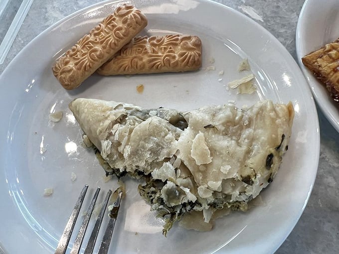 Spinach pie with layers so delicate they could moonlight as origami. The filling whispers of garlic and feta in perfect harmony.