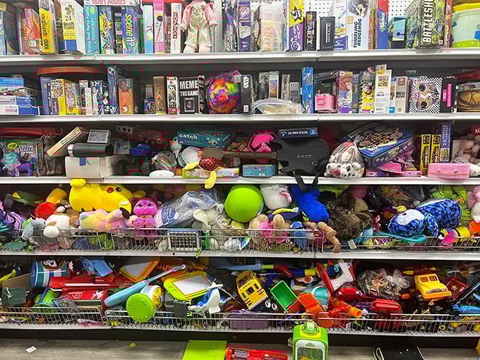 Toy shelves bursting with childhood memories. Someone's forgotten Monopoly game sits beside stuffed animals waiting for their second chance at being loved.