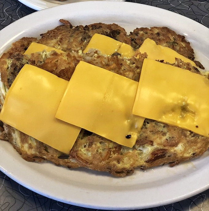 An omelet that's seen things. Those cheese slices aren't just toppings&mdash;they're yellow blankets of comfort for eggs that lived a good life.