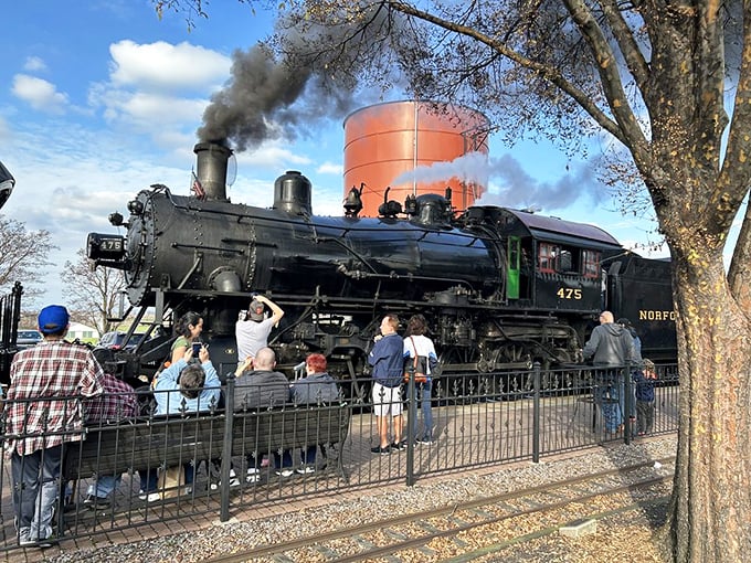 Railroad enthusiasts gather around Norfolk & Western No. 475, their cameras capturing what their hearts already know&mdash;this is mechanical poetry in motion.