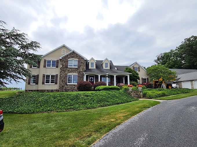 This stone-accented country estate could convince even the most dedicated city-dweller that pastoral living has its undeniable charms.