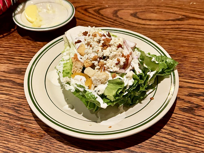 A wedge salad that doesn't apologize for being old-school. Blue cheese and bacon bits playing their greatest hits on crisp lettuce.