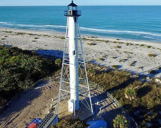 Paradise from above! The lighthouse commands this aerial view of turquoise waters meeting pristine beaches, with Boca Grande's charming streets just beyond.