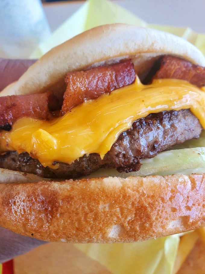 That cheese melt is performing a slow, seductive dance over the patty while bacon stands guard. A burger that demands respect&mdash;and napkins.