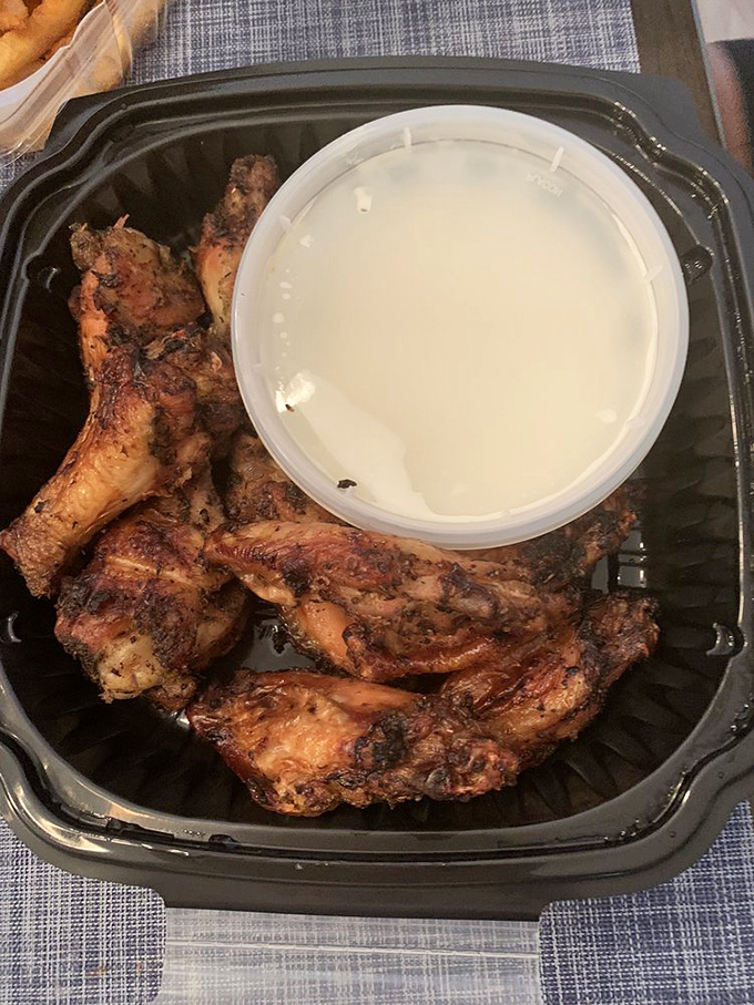 These wings aren't just cooked; they're persuaded to deliciousness. The dipping sauce is standing by like a loyal friend.