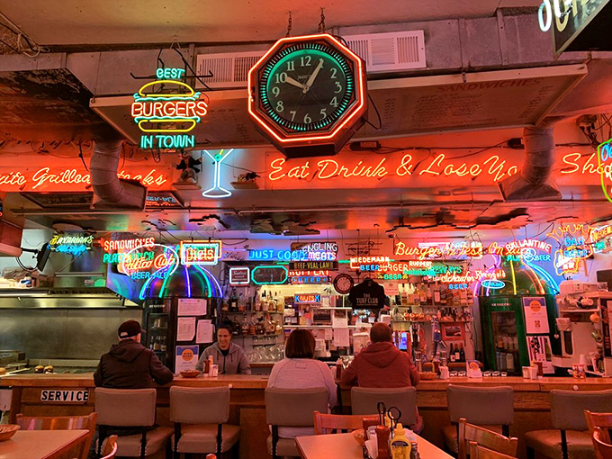 The neon-lit bar isn't just serving drinks—it's serving nostalgia with a twist. "Eat, Drink & Lose Your" inhibitions, presumably.