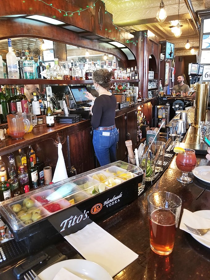 Behind this bar, mixology meets history&mdash;where classic cocktails are crafted with modern flair under the watchful gaze of that magnificent tin ceiling.