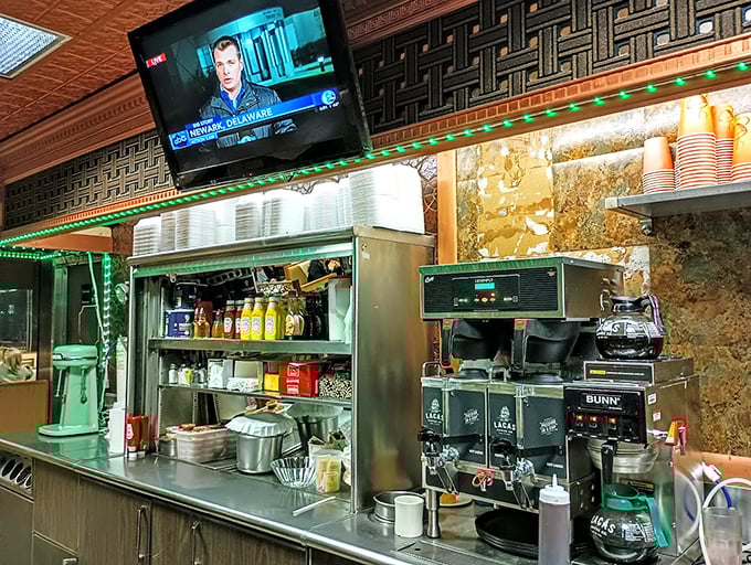 Coffee station command center where liquid energy is dispatched with military precision&mdash;the green lights adding a touch of diner disco to your caffeine fix. 