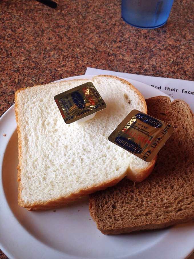 White bread with butter packets&mdash;the humble palate cleanser between bites of intensely flavorful chicken that somehow feels exactly right.