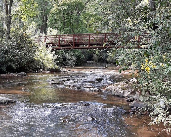 This rustic red bridge isn't just crossing water &ndash; it's connecting you to a Tennessee most tourists never see. No filter needed.