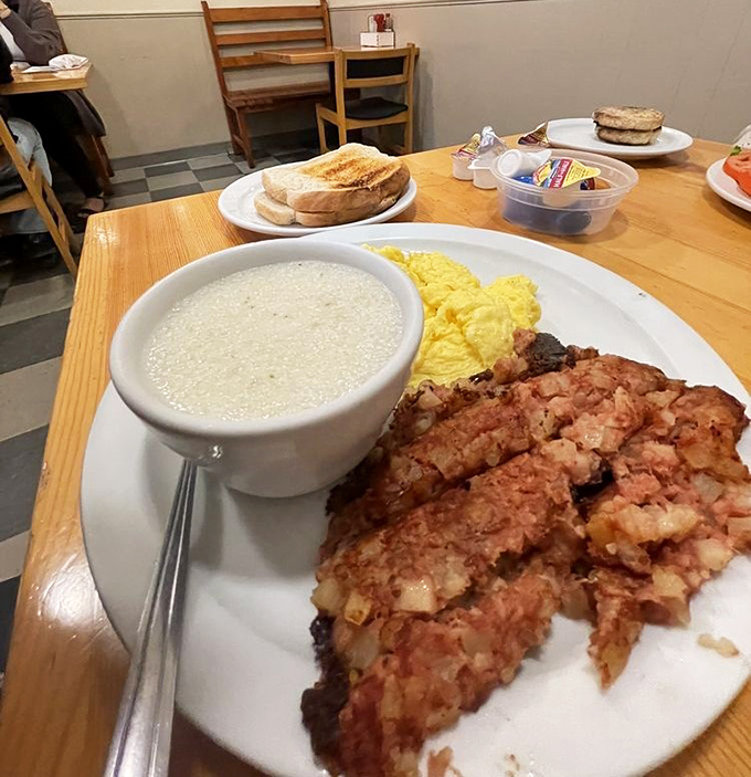 Comfort on a plate: creamy grits, scrambled eggs, and corned beef hash&mdash;the breakfast equivalent of a warm hug on a chilly morning.