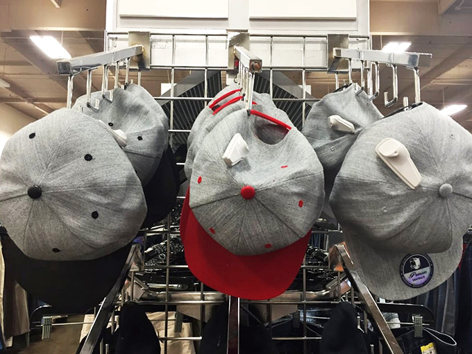 Baseball caps hang like fabric trophies, each one carrying stories of games watched and teams cheered.
