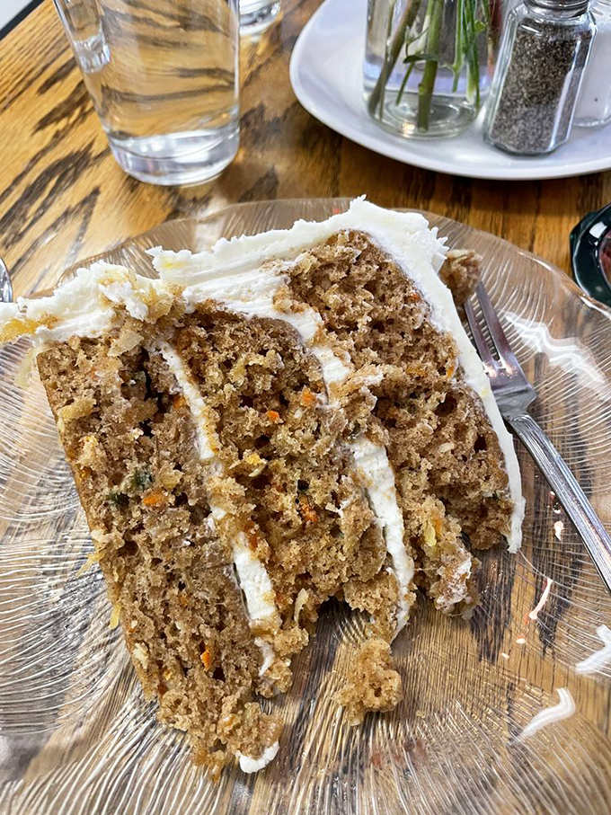 Carrot cake that actually makes you grateful vegetables exist, with cream cheese frosting thick enough to leave a mustache.