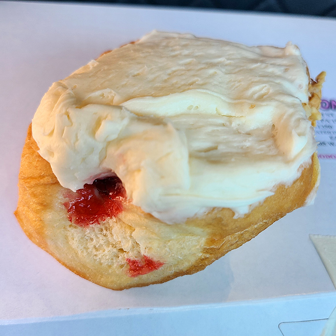 The cherry cheese donut&mdash;where fruit meets cream in perfect harmony. That bite mark tells you someone couldn't even wait for a photo.