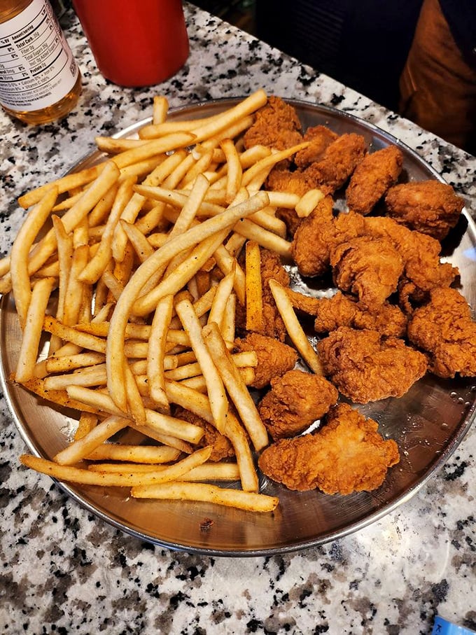 Crispy chicken bites alongside golden fries &ndash; the dynamic duo of comfort food that's never let anyone down since the dawn of time.