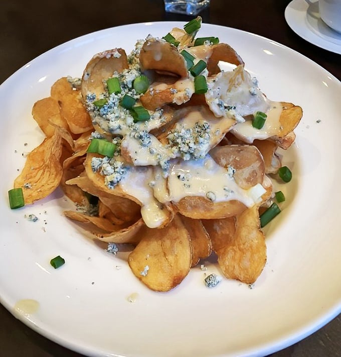 House-made potato chips drowning in blue cheese and scallions &ndash; proof that sometimes the simplest pleasures are the most profound.