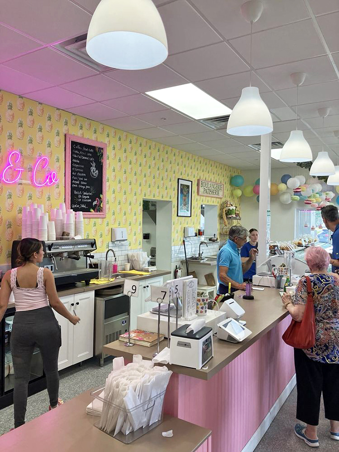Pink paneling and pineapple wallpaper create a Florida-meets-France vibe that somehow works perfectly for this charming bakery.