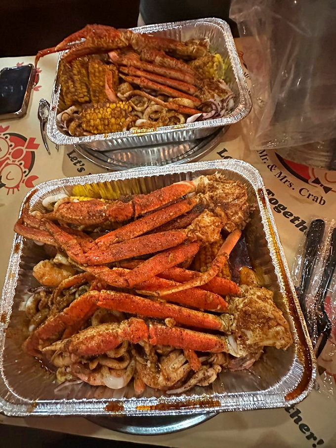 Snow crab legs arranged like nature's perfect eating utensils. The seasoning clings to every crevice, ensuring no taste bud is left behind.