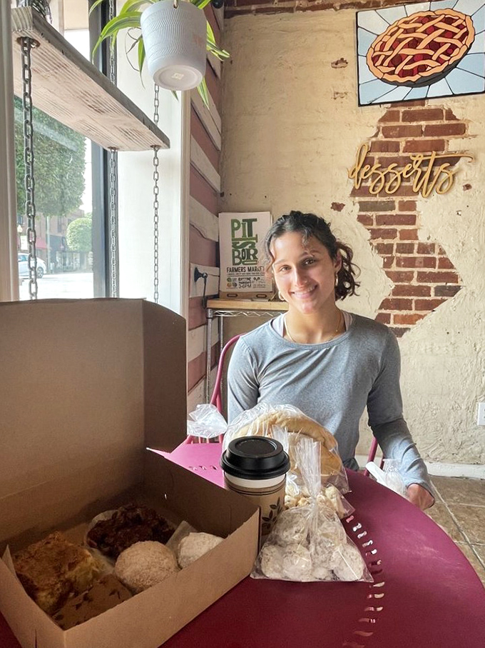 The joy of scoring the perfect bakery haul is written all over this customer's face. That box contains happiness in carbohydrate form.