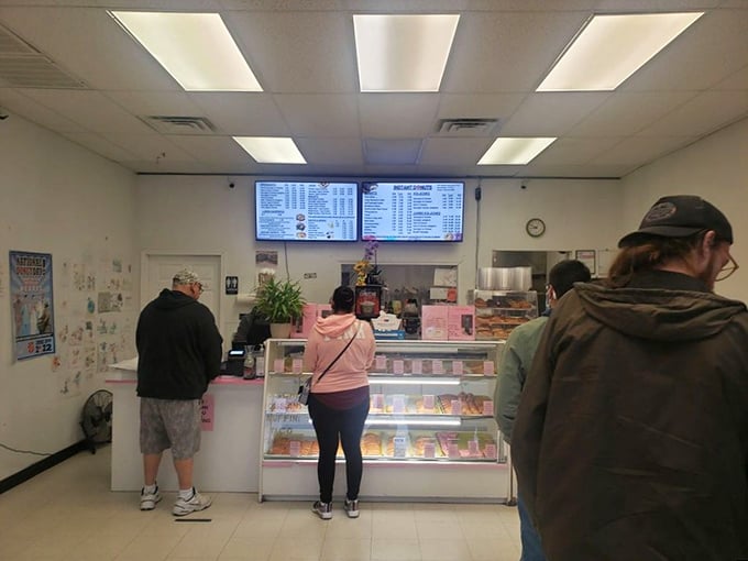 The morning pilgrimage to the donut counter &ndash; a ritual as old as time itself. These customers know that good things come to those who wait.