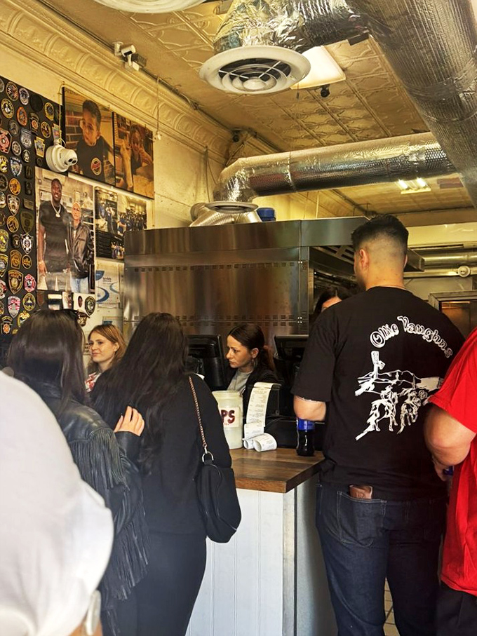 The daily pilgrimage of the sandwich faithful. Customers patiently waiting their turn, knowing that greatness can't be rushed and some things are worth standing in line for.
