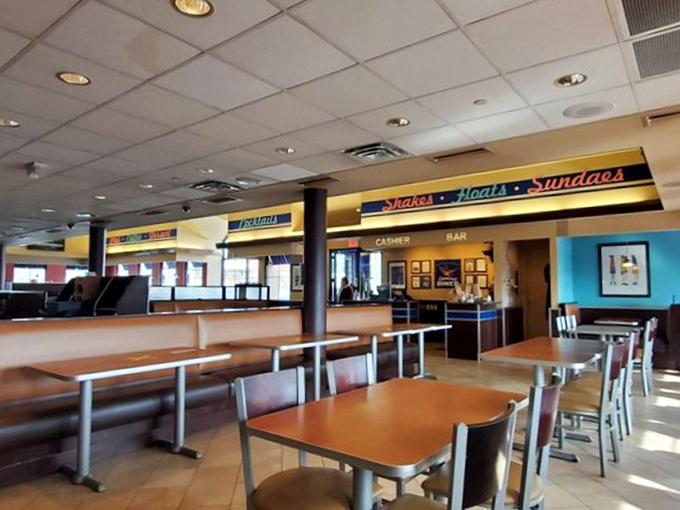 The dining area's clean lines and comfortable seating invite you to settle in. That "Shakes &bull; Malts &bull; Sundaes" sign is practically whispering sweet nothings.