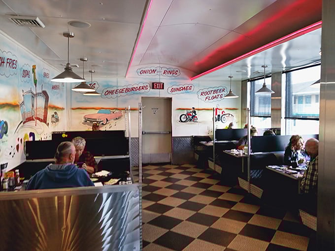 The mural says "cheeseburgers and root beer floats," but the booths say "stay awhile and solve the world's problems over coffee."
