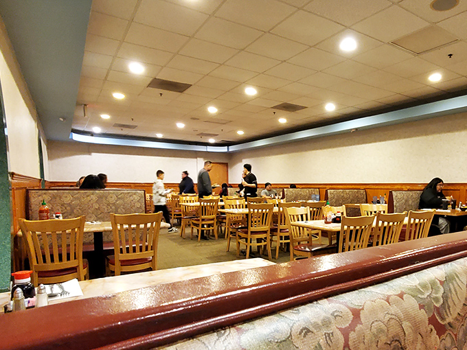 Where food dreams become reality – diners plotting their next buffet conquest while servers maintain the delicate ecosystem of endless eating.