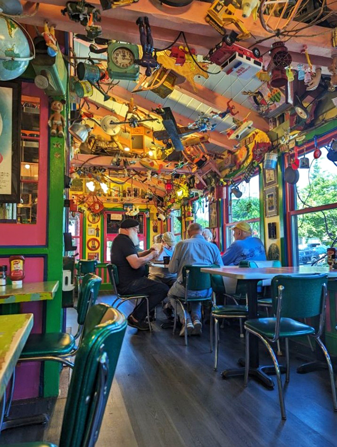 Diners enjoy their meals beneath a ceiling where childhood toys have formed their own gravity-defying community&mdash;conversation starter included at no extra charge.